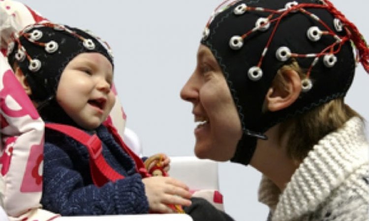 Parents’ brains ‘sync up’ with their infant’s when they play together ...